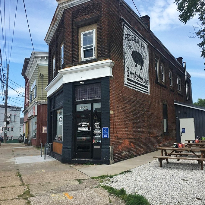 The corner brick building with its simple picnic table seating says, "We focus on what's inside, not fancy frills."