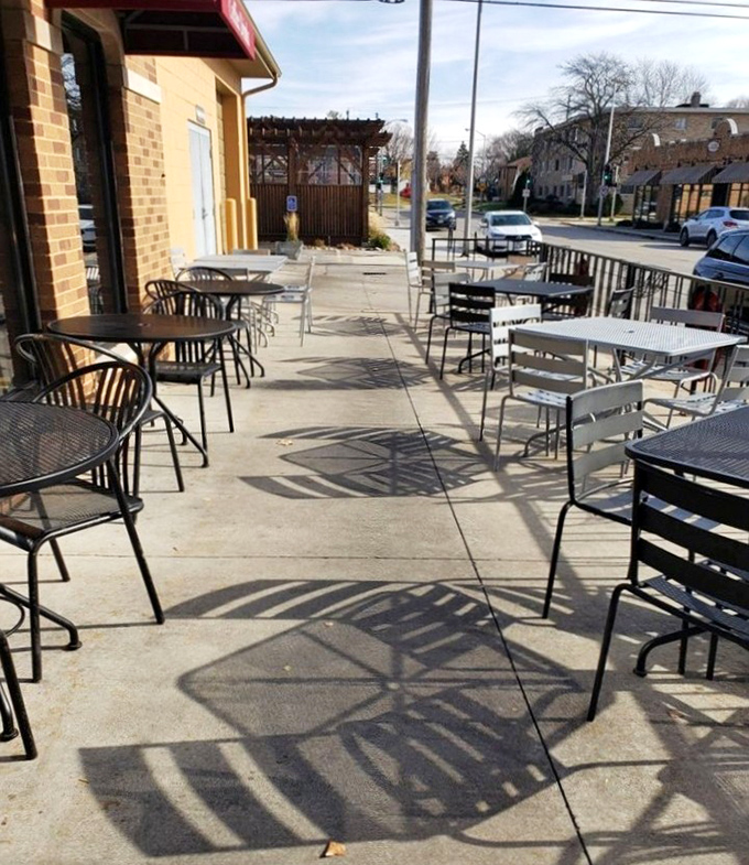 The patio where cheese dreams come true under open skies, proving that some of life's greatest pleasures are enjoyed at simple metal tables.