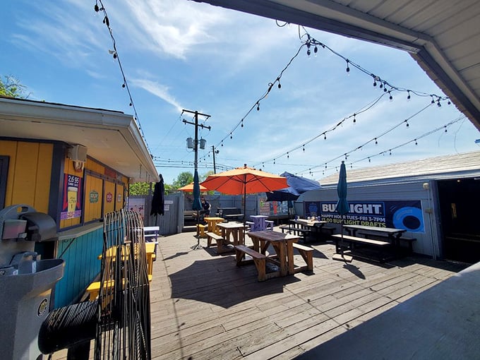 The outdoor patio, where string lights twinkle above wooden picnic tables, turning simple seafood meals into memory-making occasions.