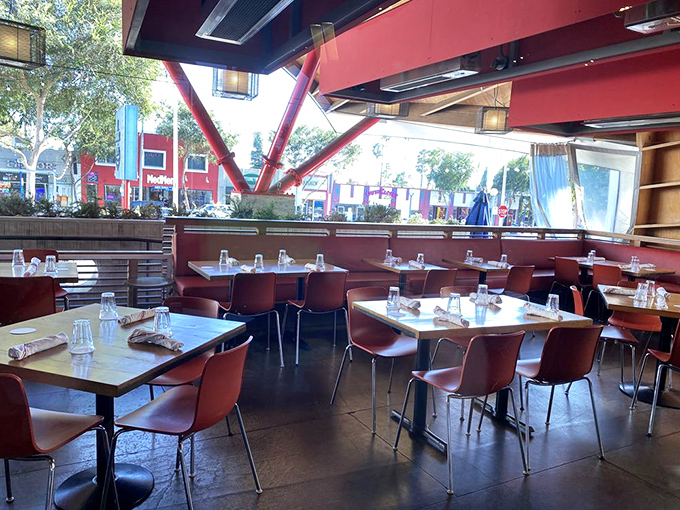 The dining room's clean lines and abundant natural light create the perfect backdrop for seafood feasts. Those red chairs have supported countless food comas.