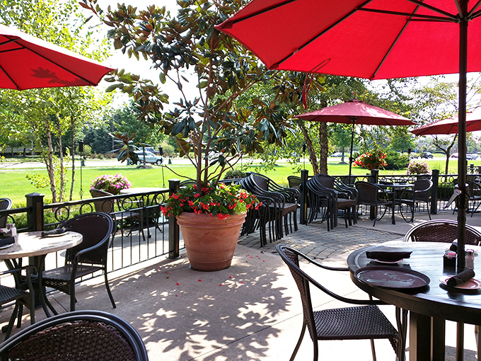 Red umbrellas stand guard over the outdoor seating area, creating a cheerful haven for al fresco dining when Ohio weather cooperates.