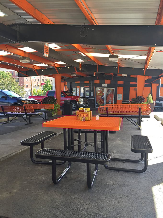 Outdoor seating that says, "Stay awhile." Orange tables that match the building&mdash;because when you've found your color scheme, you commit.