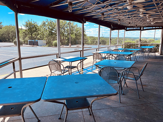 The covered patio with bright blue tables offers al fresco dining with a view &ndash; because barbecue somehow tastes even better with a side of fresh air.