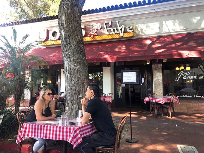 Outdoor dining under the dappled shade of California trees&mdash;where breakfast conversations flow as freely as the coffee refills.