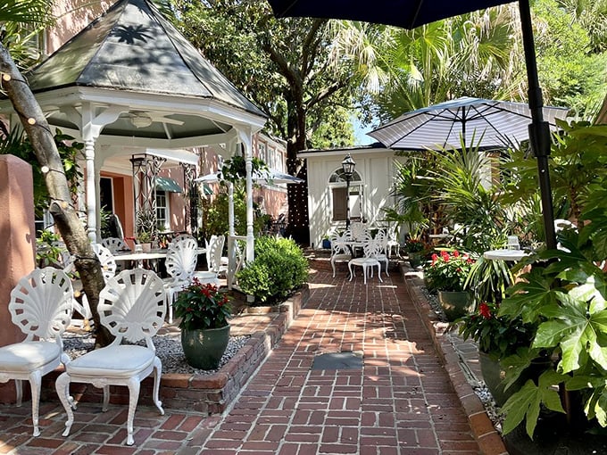 The courtyard dining area is Charleston's worst-kept secret&mdash;dappled sunlight, brick pathways, and white garden furniture create an oasis in the historic district. 