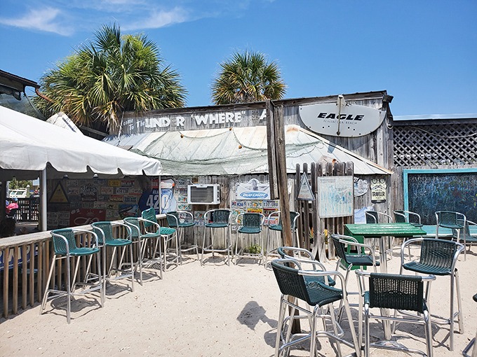Sandy outdoor seating where the Gulf breeze does the air conditioning. Paradise with a side of people-watching and cold beverages.
