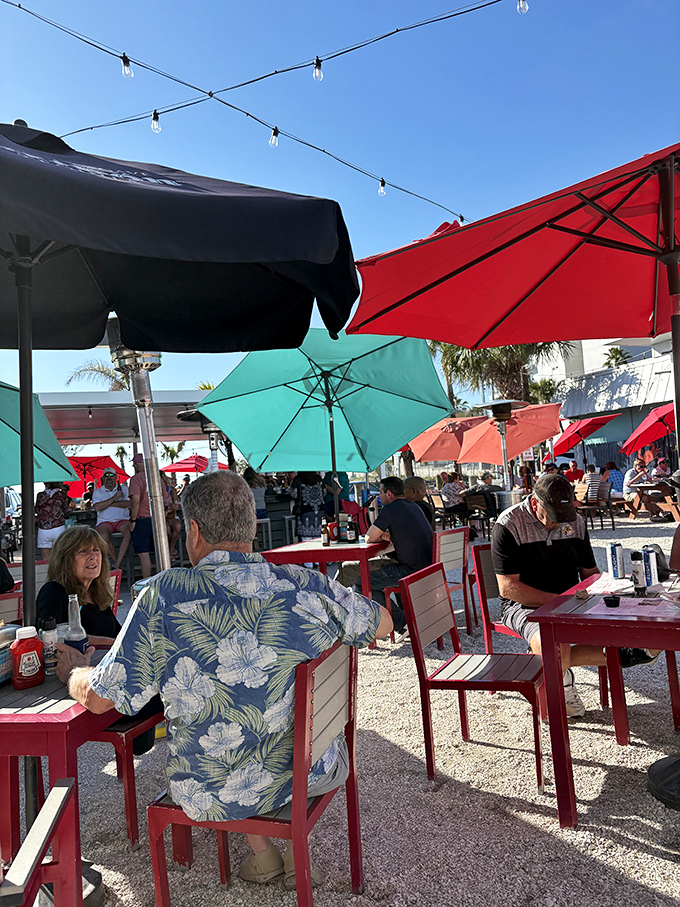 Outdoor dining under colorful umbrellas, where Hawaiian shirts are the uniform and conversations flow as freely as the cocktails on a perfect Florida afternoon.