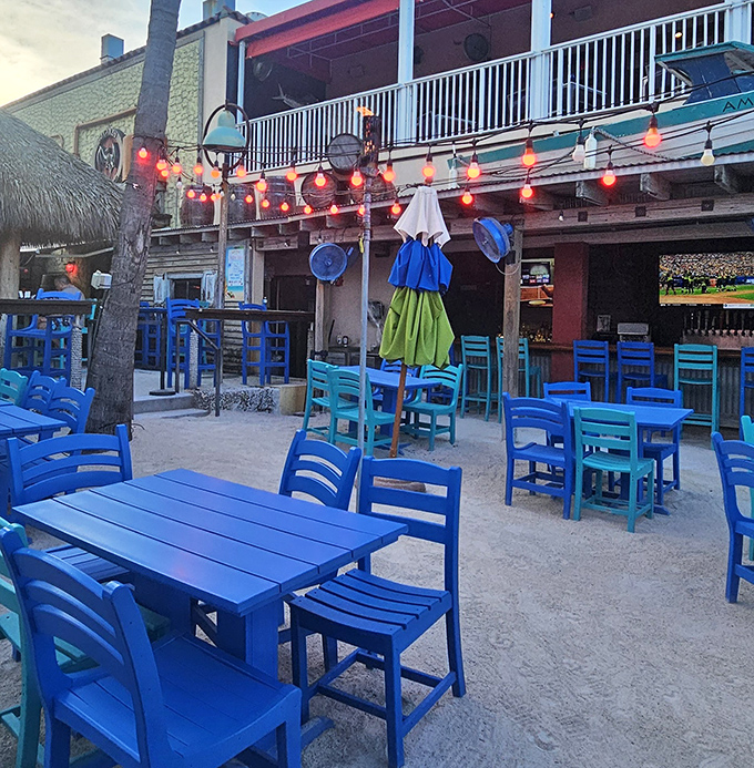 The outdoor area's brilliant blue furniture matches the Florida sky, creating a tropical oasis where sandy feet are welcome and cold drinks are mandatory.