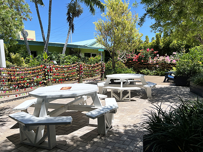 The outdoor seating area offers a tranquil spot to savor your slice, surrounded by tropical plants and those famous love locks.