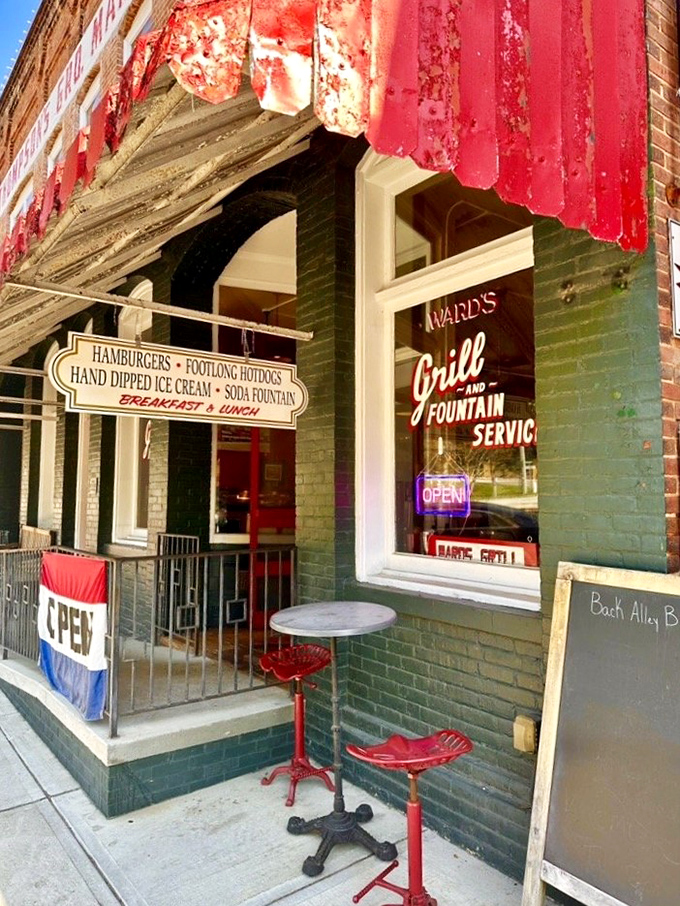 The entrance that's welcomed hungry visitors for generations. Those red stools outside aren't just seating&mdash;they're front-row tickets to Main Street's parade of life. 