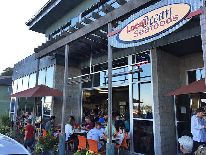 Where indoor comfort meets outdoor charm. The bustling patio scene suggests a universal truth: fresh seafood tastes even better with a side of fresh air.