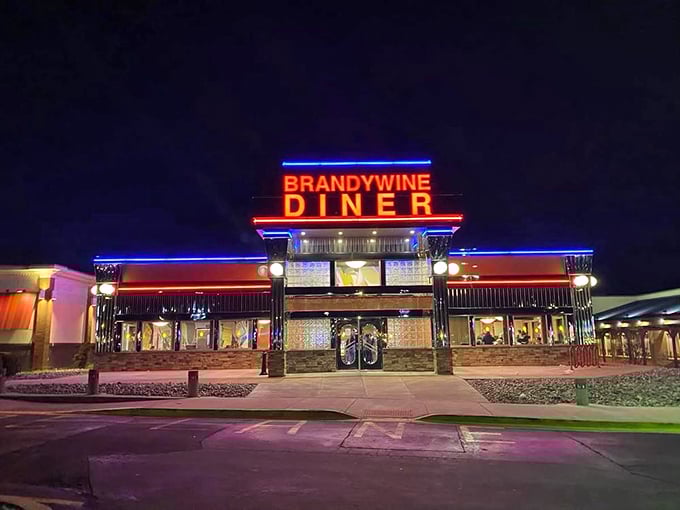 At night, the Brandywine transforms into a neon-lit temple of comfort food, beckoning weary travelers with its warm glow.