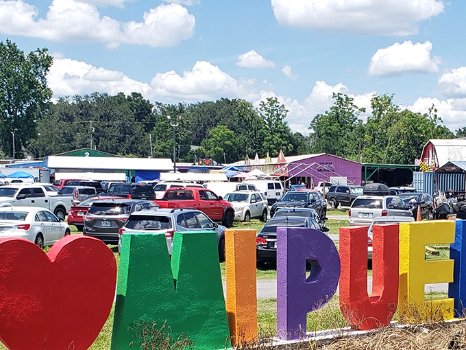 The colorful "MI PUEBLO" sign welcomes visitors to this bustling marketplace, where full parking lots hint at the treasures waiting inside.