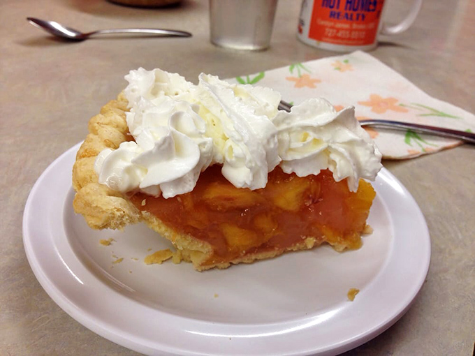 Peach pie topped with a cloud of whipped cream&mdash;proof that sometimes dessert is just breakfast waiting for the right moment.