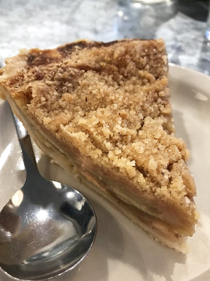 A slice of pie that makes you consider ordering dessert at breakfast. The crumb topping is giving "grandma's secret recipe" energy in all the right ways.