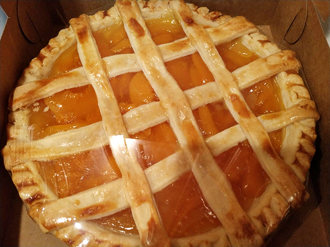 A lattice-topped fruit pie that belongs in a museum of edible art. Those golden-brown strips aren't just crust – they're pathways to happiness.