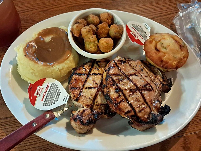 Pork chops with grill marks so perfect they deserve their own Instagram account. That mound of mashed potatoes isn't just a side&mdash;it's a gravy reservoir.