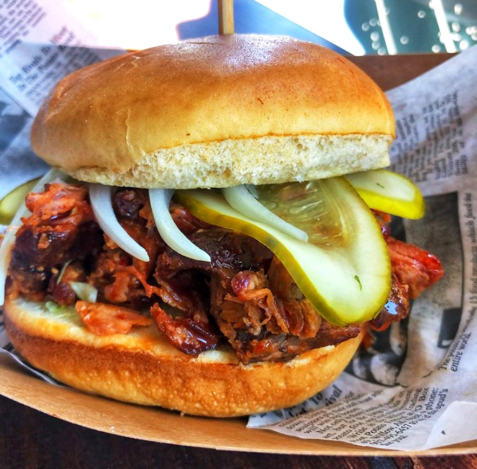 Pulled pork that's had a proper introduction to smoke and time. Topped with pickles and onions for contrast, it's the sandwich equivalent of a standing ovation.