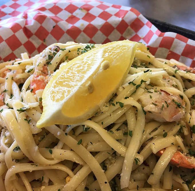 Shrimp scampi that would make an Italian grandmother nod in approval. That lemon wedge isn't garnish&mdash;it's the finishing touch on a pasta masterpiece.