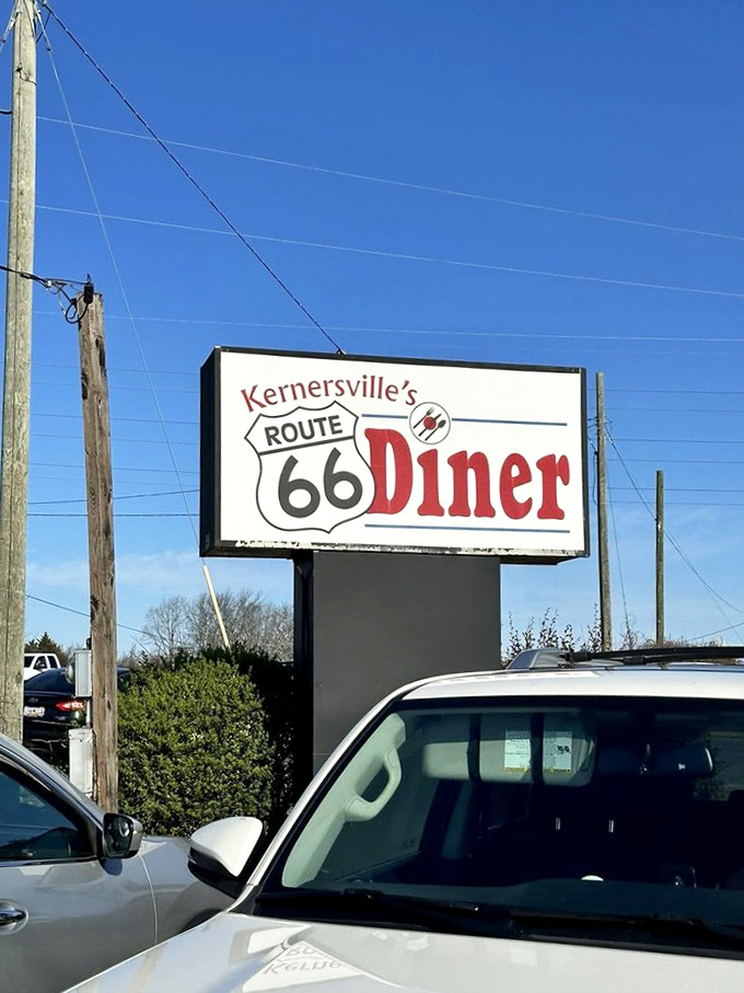 The roadside sign stands tall against Carolina blue skies, promising hungry travelers a taste of Route 66 without leaving North Carolina.