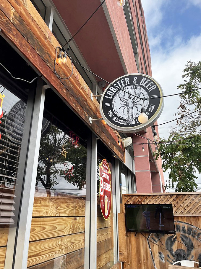 The circular sign promises exactly what awaits inside&mdash;no false advertising here, just lobster and beer in your neighborhood.