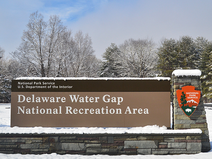 Winter transforms the park entrance into a snow globe scene. The sign might as well read: "Adventure continues regardless of season."