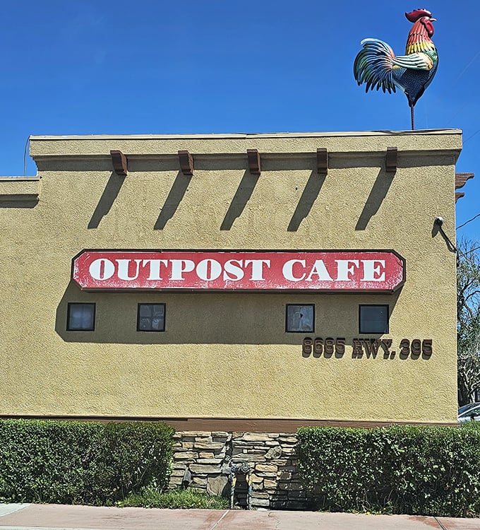 The rooster stands guard atop the Outpost Cafe sign, crowing about good food to anyone with the sense to stop.