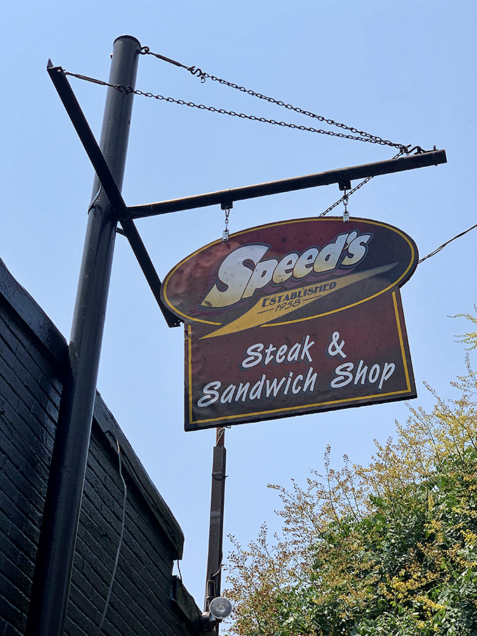 The vintage hanging sign serves as a beacon for sandwich pilgrims seeking salvation between two pieces of bread.
