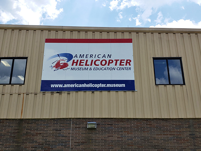 The museum's exterior signage promises adventure within&mdash;a portal to a world where humans conquered gravity with spinning blades and engineering ingenuity.