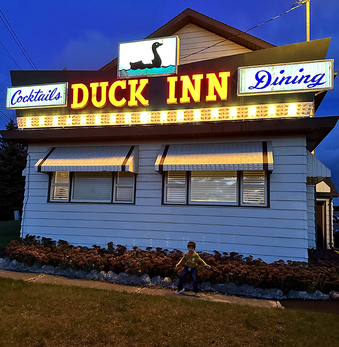 That neon sign against the twilight sky &ndash; a beacon of culinary promise that's guided hungry travelers for generations. Resistance is futile.