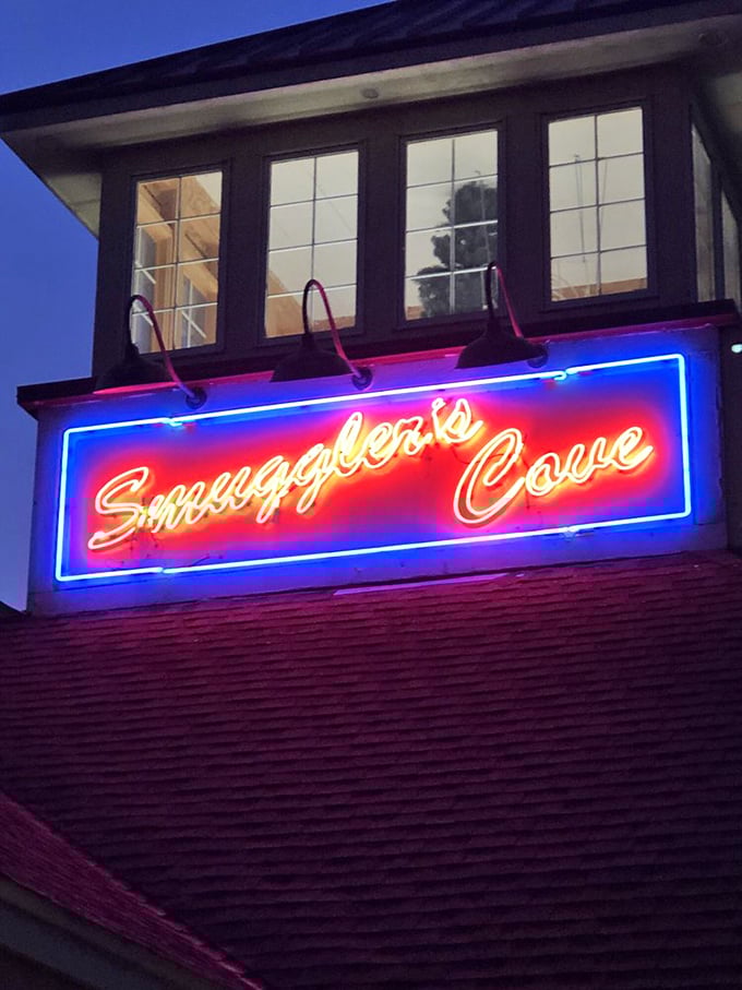 The neon sign glows like a lighthouse at dusk, guiding hungry travelers to safe harbor where lobster dreams come true.