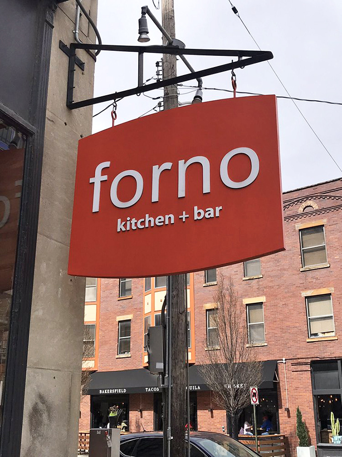 The iconic orange sign serves as a beacon for the pizza-deprived. Like a North Star for hungry explorers navigating the Short North's culinary landscape.