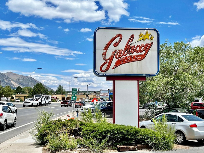 Under Flagstaff's brilliant blue skies, the roadside sign stands as a landmark for hungry travelers and a beacon of hope for empty stomachs.