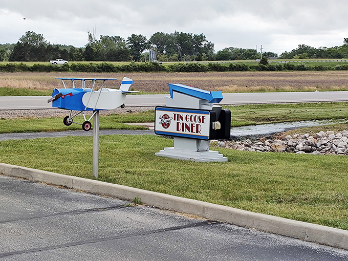 The roadside sign featuring a miniature airplane points the way to culinary happiness. Follow it for breakfast bliss.