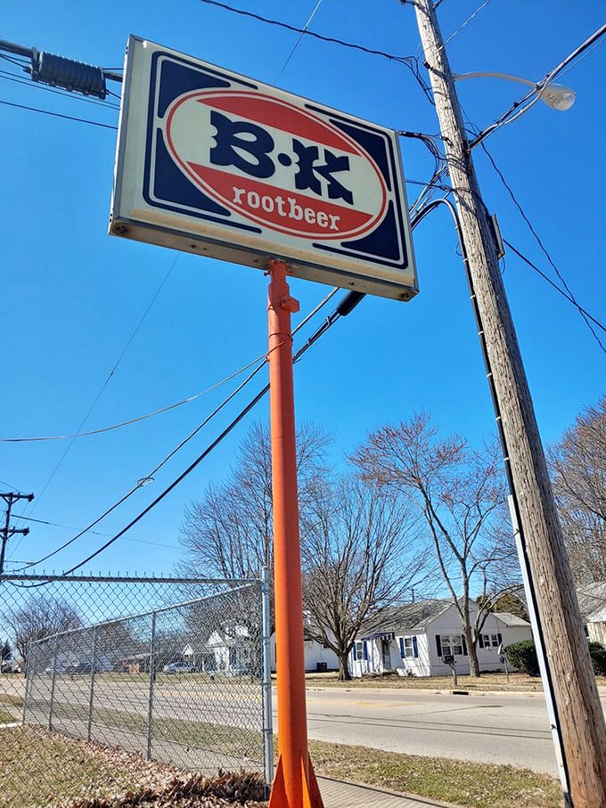 The iconic B-K sign stands against the blue Ohio sky like a beacon, guiding hungry travelers to a place where root beer flows and time slows down.