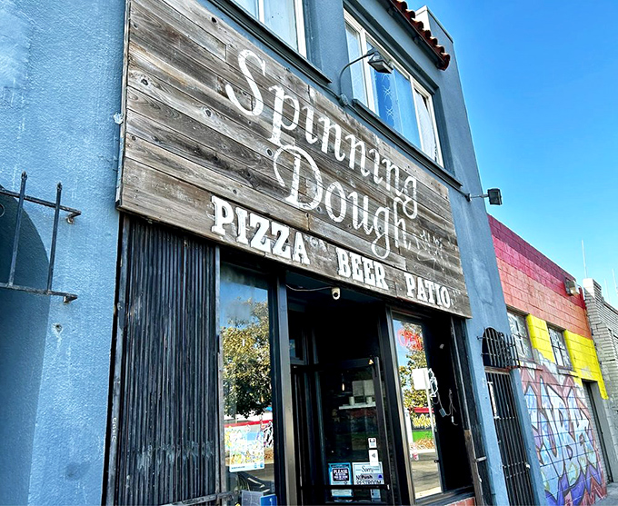 Morning sunshine bathes the Spinning Dough sign in golden light, like nature's way of highlighting your next great meal destination.