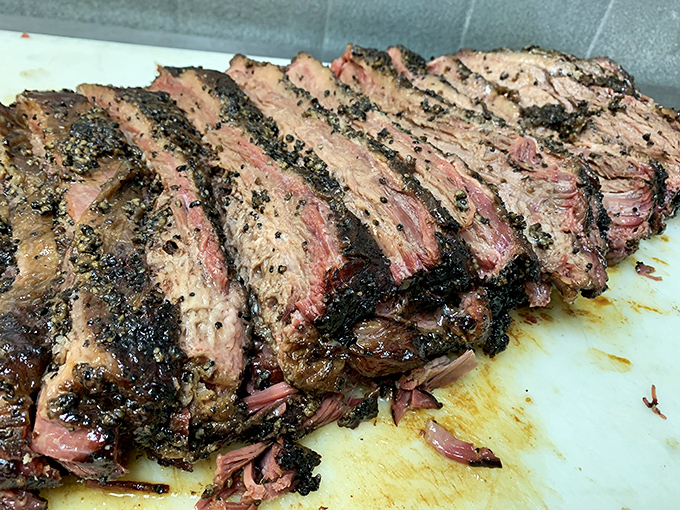 Brisket sliced with the reverence it deserves. Each piece tells the story of patience, smoke, and Texas tradition.