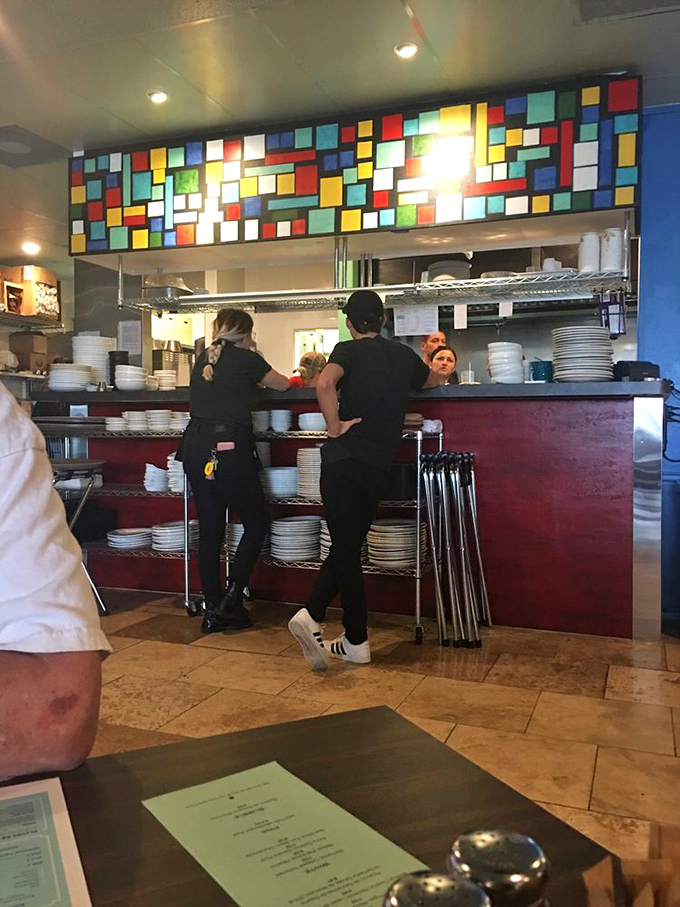 Behind the colorful stained-glass divider, culinary magicians transform simple ingredients into the stuff of Tex-Mex dreams.