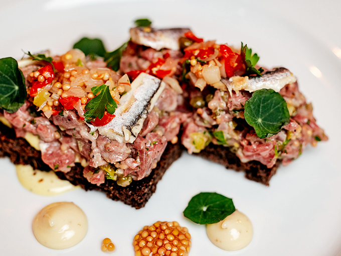 Steak tartare that's dressed better than most people at the table, with perfect little dots of aioli standing by like culinary exclamation points.