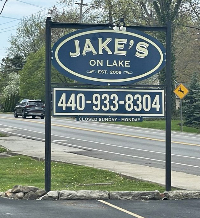 The sign that's guided hungry travelers to perch paradise since 2009—like a blue beacon of hope for those seeking seafood salvation on Lake Road.