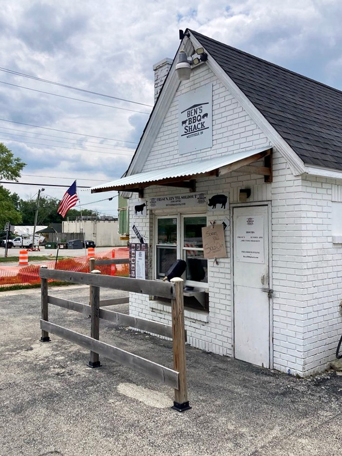 The unassuming storefront with its wooden fence and American flag. This little white building houses big, bold flavors that put Westfield on the BBQ map.
