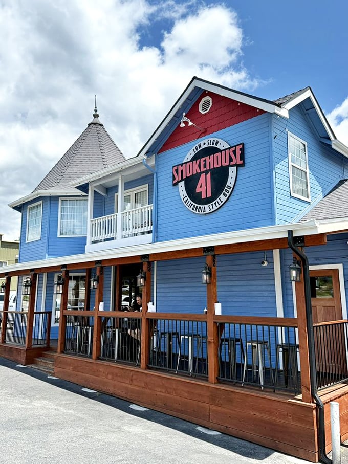 The distinctive blue exterior with its bold logo serves as a lighthouse for the BBQ-obsessed, guiding hungry travelers home.