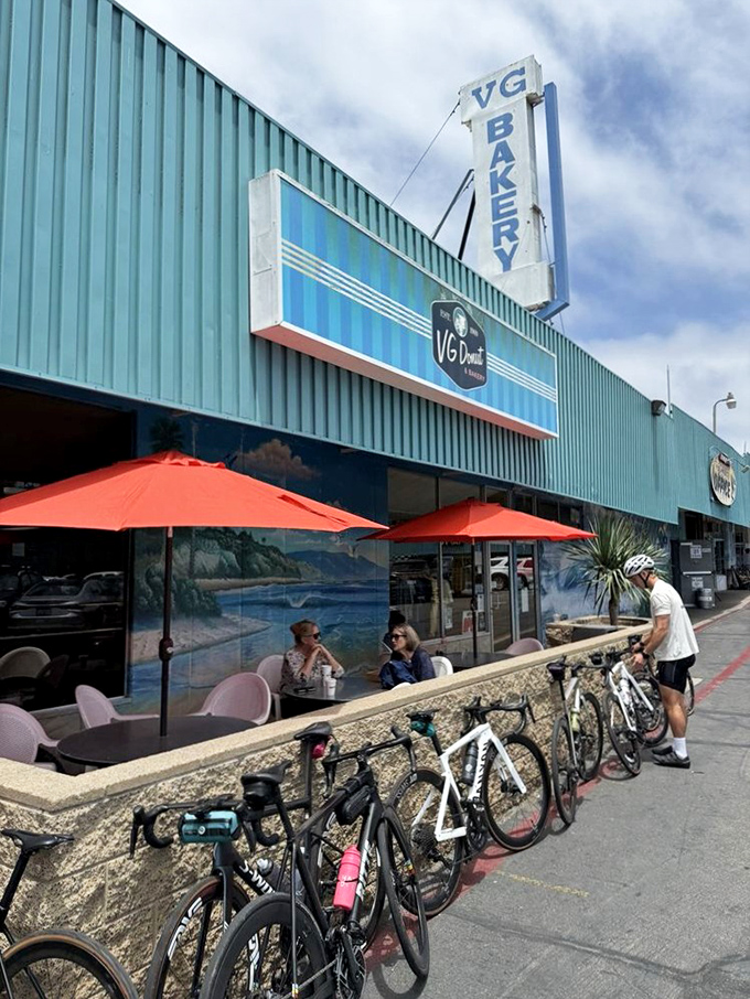 Cyclists gather outside the iconic blue storefront, proving that even those burning thousands of calories can't resist VG's siren call.