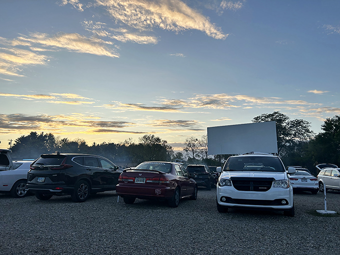 Sunset at the drive-in offers nature's opening act, painting the sky before Hollywood takes over the canvas.