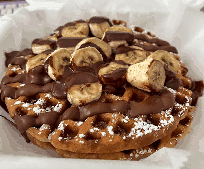 This waffle didn't just get dressed—it got dressed for the Oscars, with chocolate, bananas, and powdered sugar playing supporting roles.