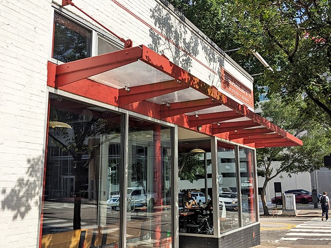Beasley's modern storefront beckons with its bright red awning &ndash; a crispy chicken sanctuary hiding in plain sight on Raleigh's bustling streets.