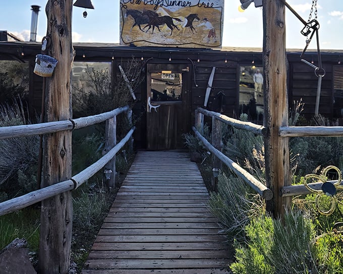 The entrance to Cowboy Dinner Tree beckons like a portal to the Old West. That wooden walkway practically whispers, "Come hungry, leave happy."