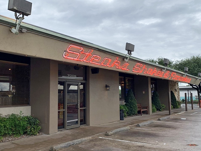 The neon glow of Dot Coffee Shop's sign is like a beacon for hungry souls. Classic comfort food awaits inside this Houston institution.