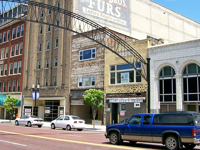 Flint's historic downtown welcomes visitors with a charming metal archway, like a portal to the city's architectural treasures.