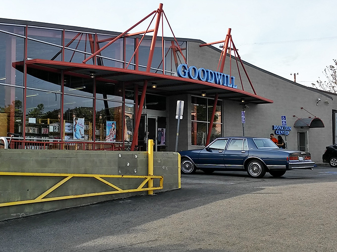 That distinctive red framework says "welcome to treasure hunting headquarters" - Goodwill's architectural promise of endless discoveries. 